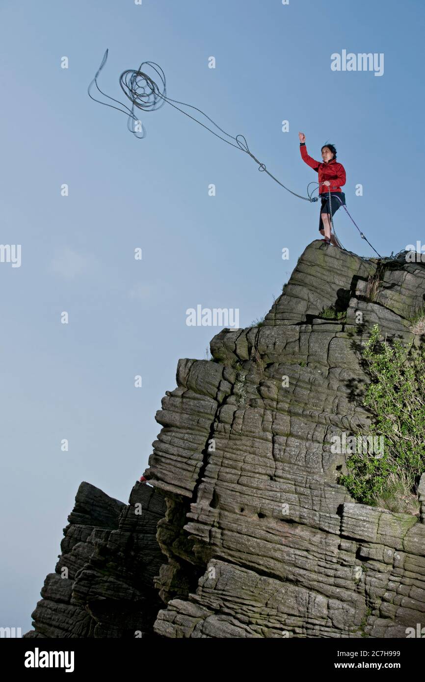 woman throwing rope at Windgather rocks in the British Peak District ...