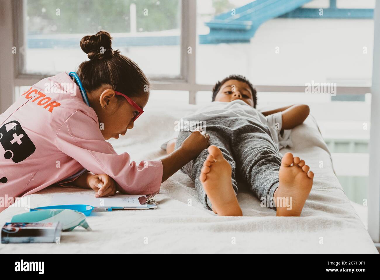 Kids playing doctor hi-res stock photography and images - Alamy