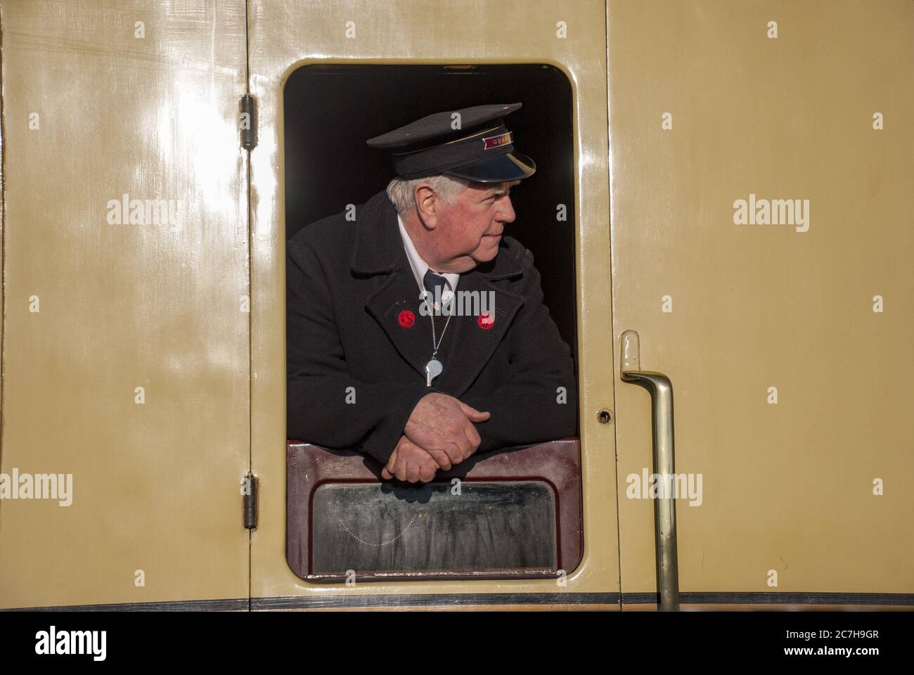 DIDCOT, UNITED KINGDOM - Feb 17, 2008: Guard leaning out of a steam ...