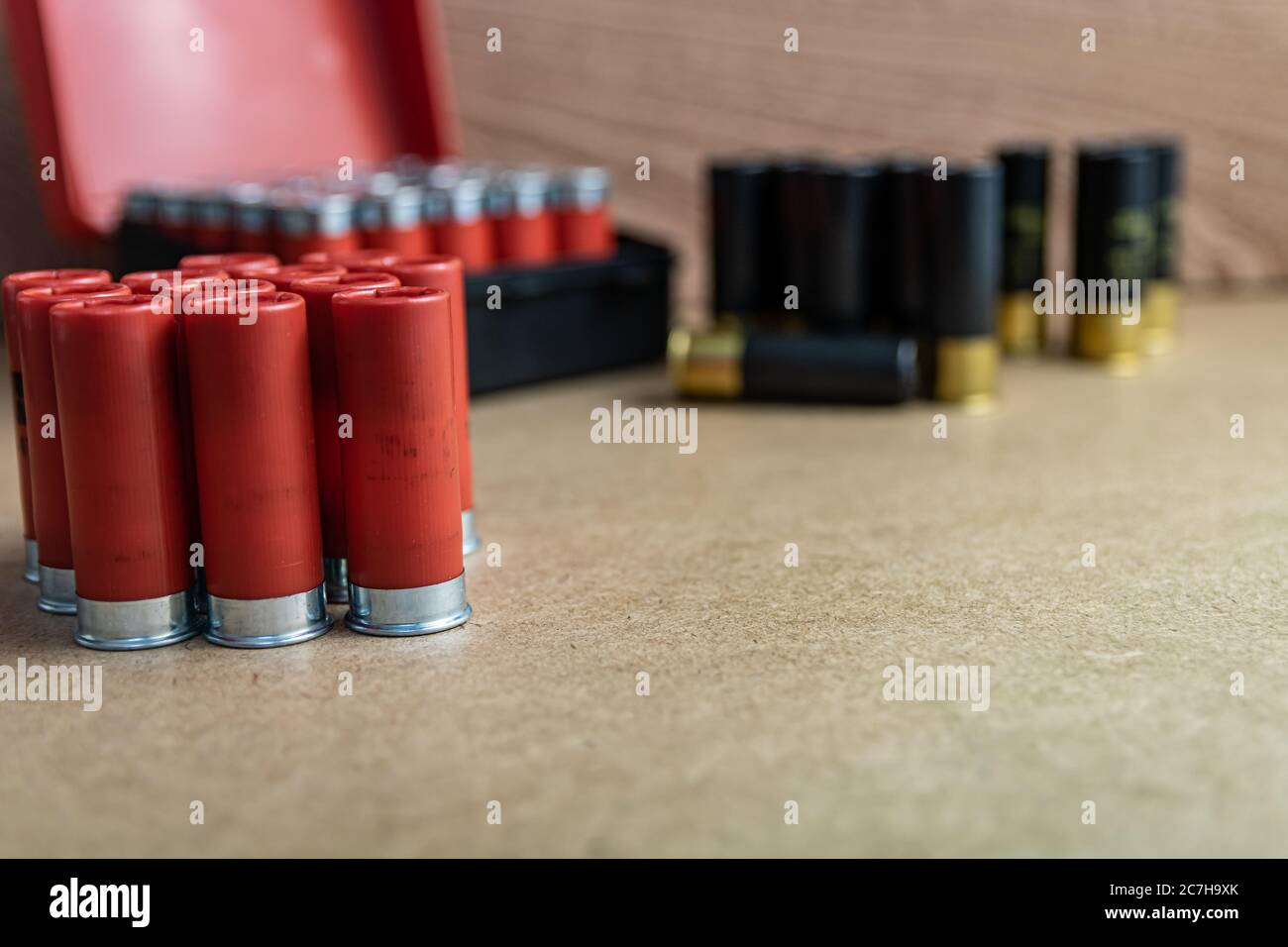 Selective focus shot of red shotgun ammo on a brown surface Stock Photo ...