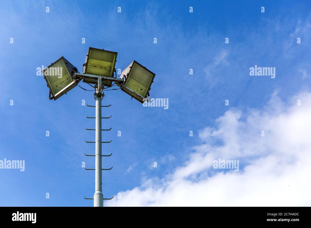 Reflector light for playground on blue sky background. Halogen light on ...