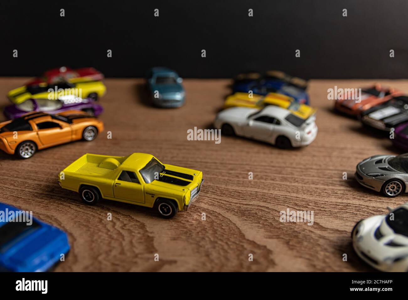 Selective focus shot of a yellow toy car on a wooden surface Stock ...