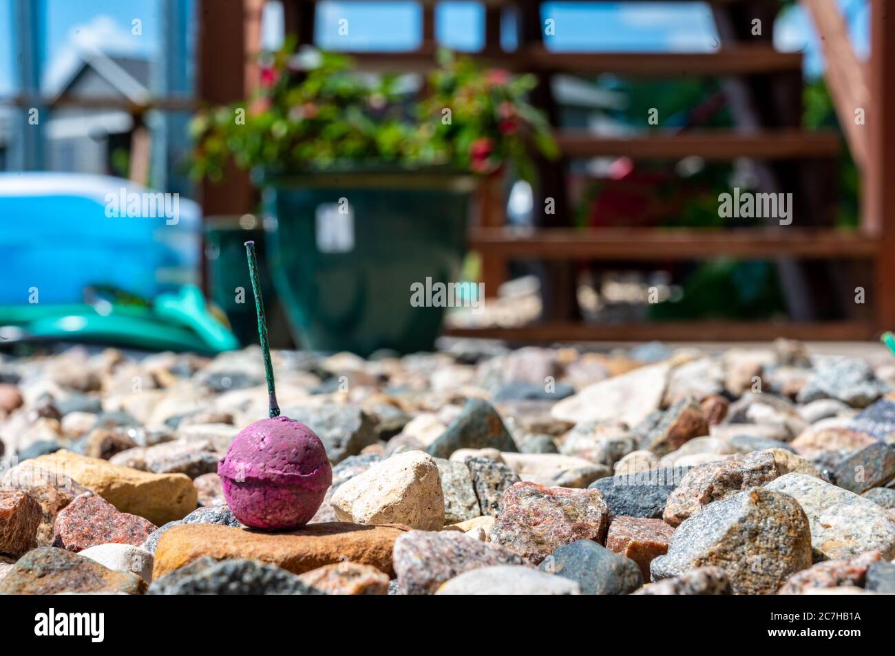 Low level view of a smoke bomb being lit and shooting smoke out the top ...