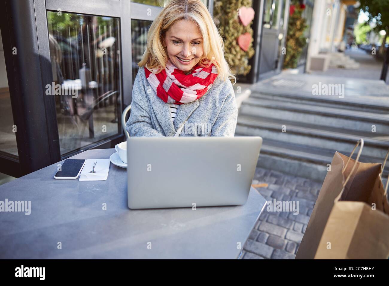 Beautiful lady resting in cafe with laptop Stock Photo - Alamy