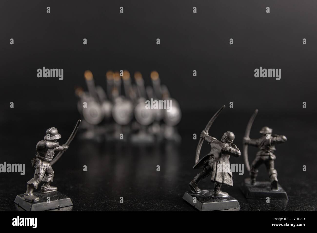 Grayscale selective focus shot of soldier with bows figurines Stock ...