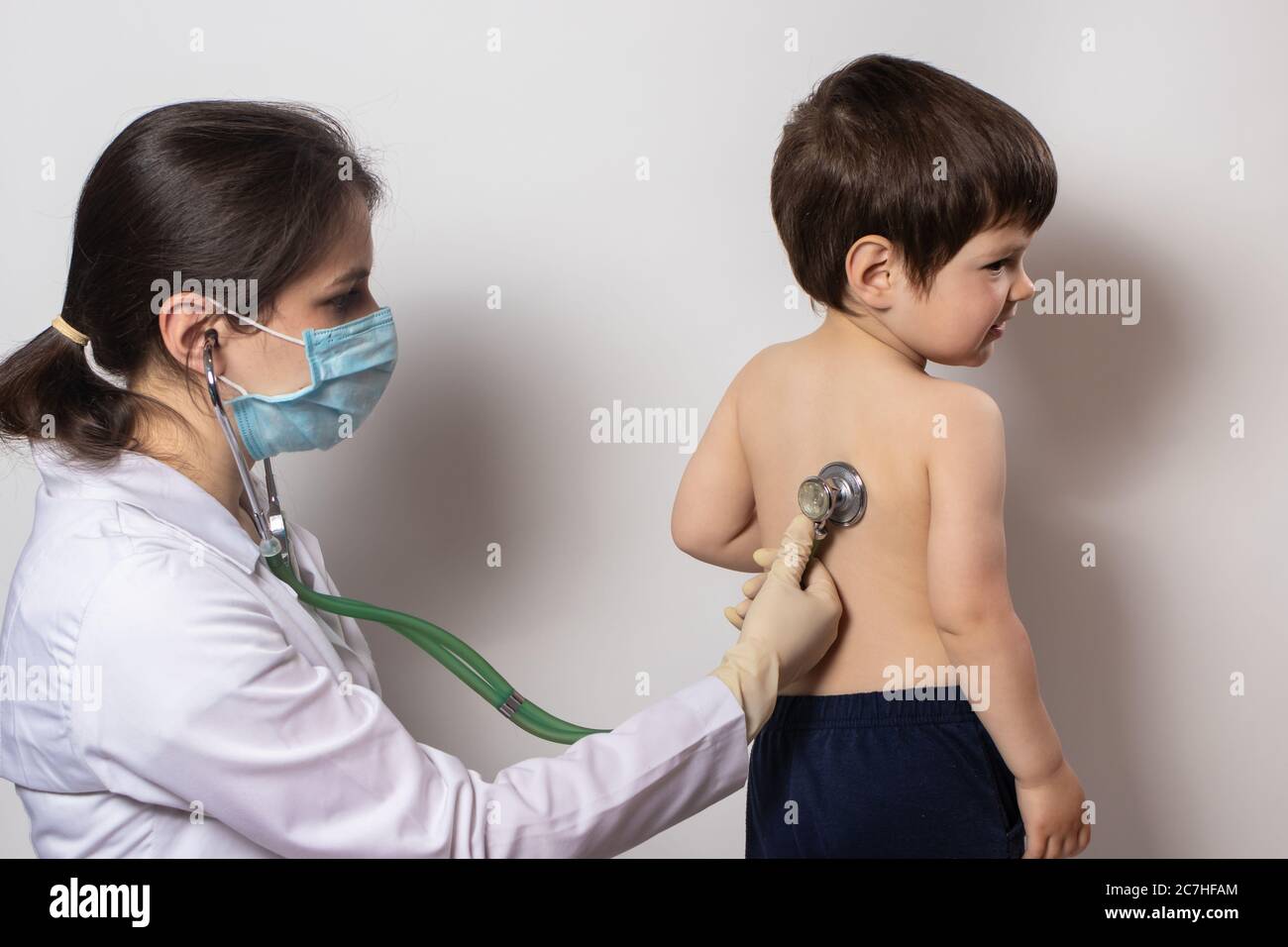 Pediatric examination of a child with a stethoscope. Little boy and ...