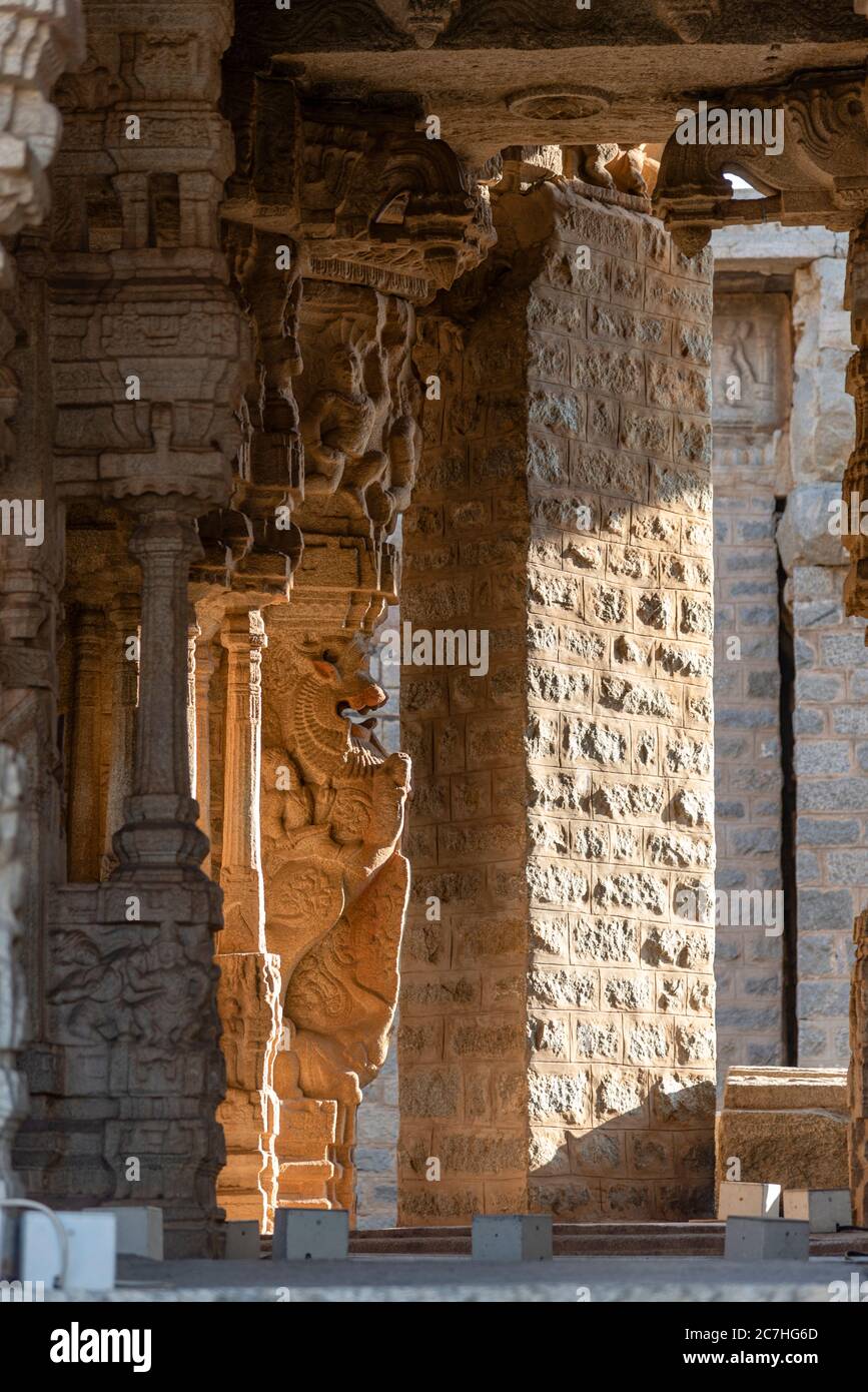 Light falling on the temple pillar and illuminating the sculpture next ...