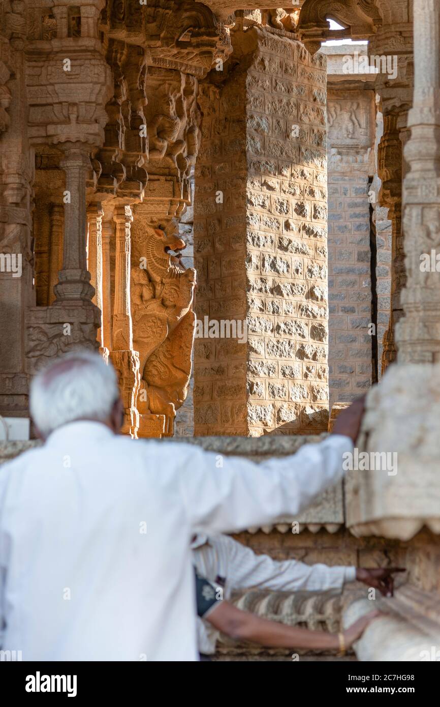 People in front of an illuminated temple pillar Stock Photo - Alamy