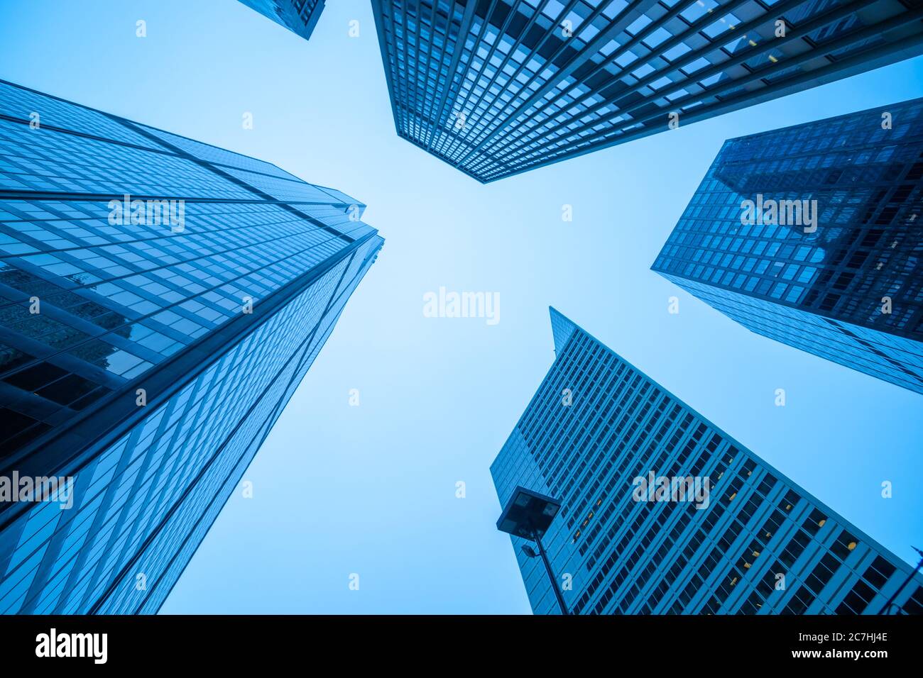 Converging high-rise commercial office buildings in blue hues towering ...