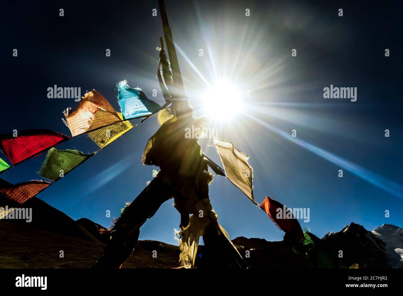 Buddhist banners blowing in the wind with the sun shines with rays in ...