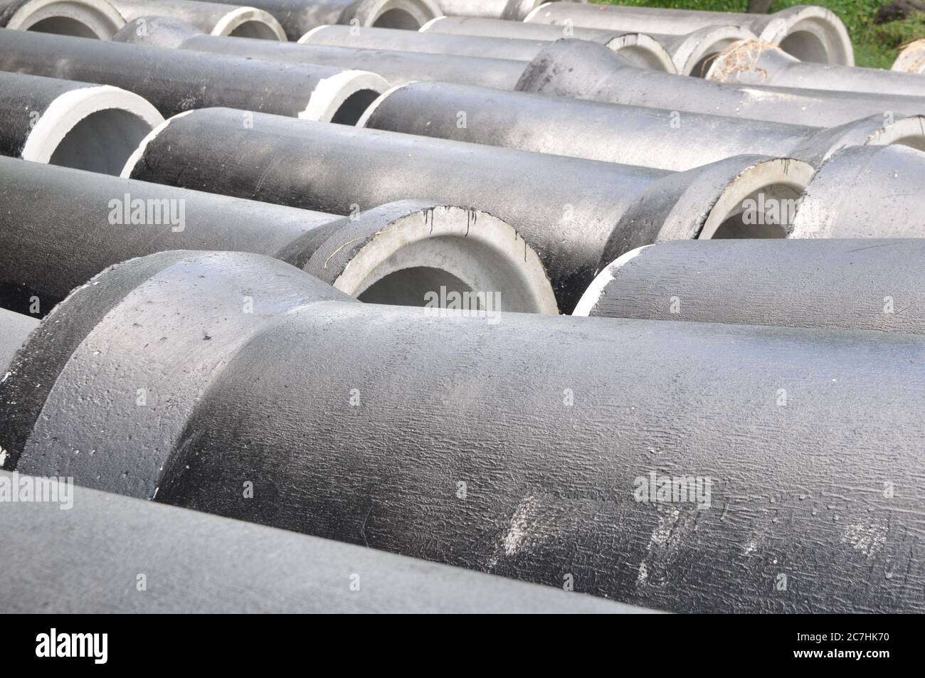 concrete pipes coated with protective mastic at a construction site ...