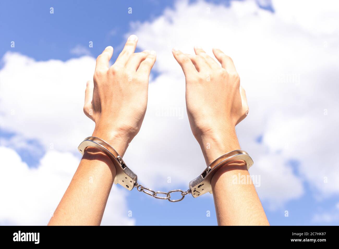 Close up two hands in handcuffs and put your hands up for freedom ...
