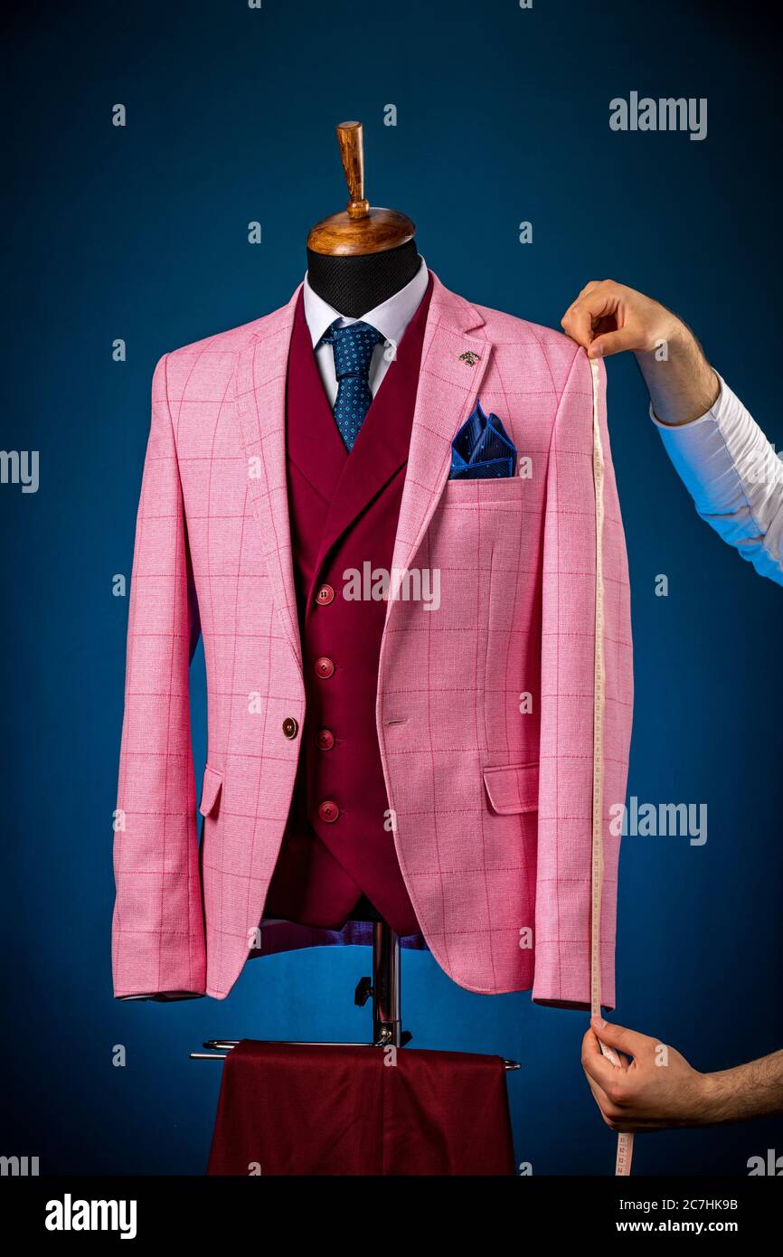 image of dressmaker or tailor using tape measure on mannequin or dummy ...