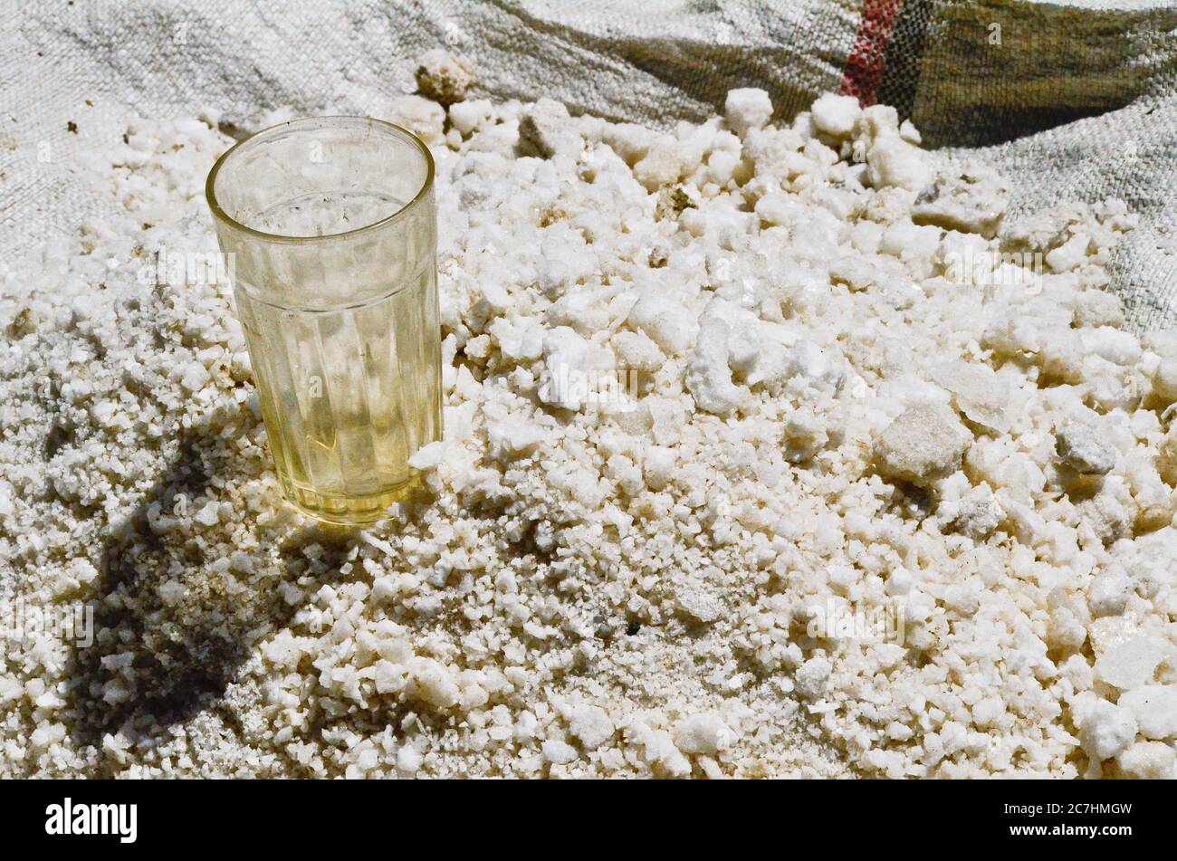 Glass cup on a surface covered with salt Stock Photo - Alamy