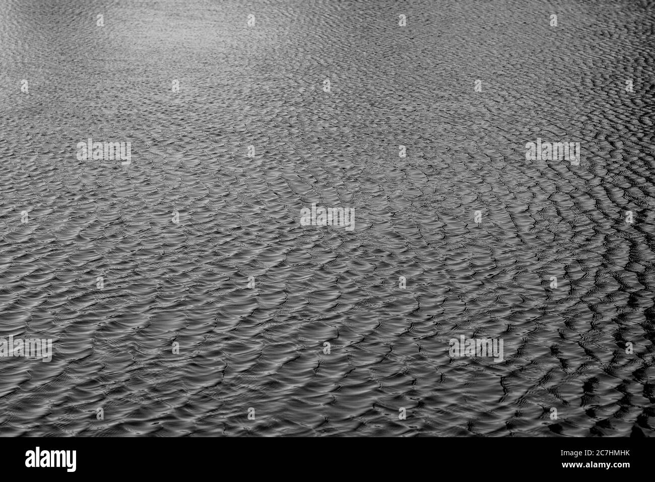 Grayscale shot of a sea with small waves Stock Photo - Alamy
