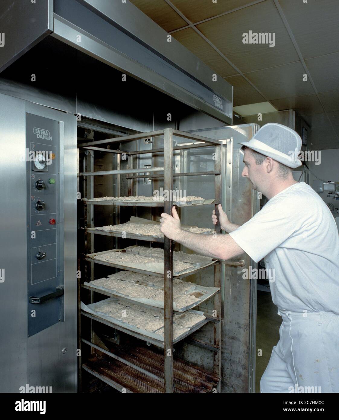 Baker Loading Oven Stock Photo - Alamy