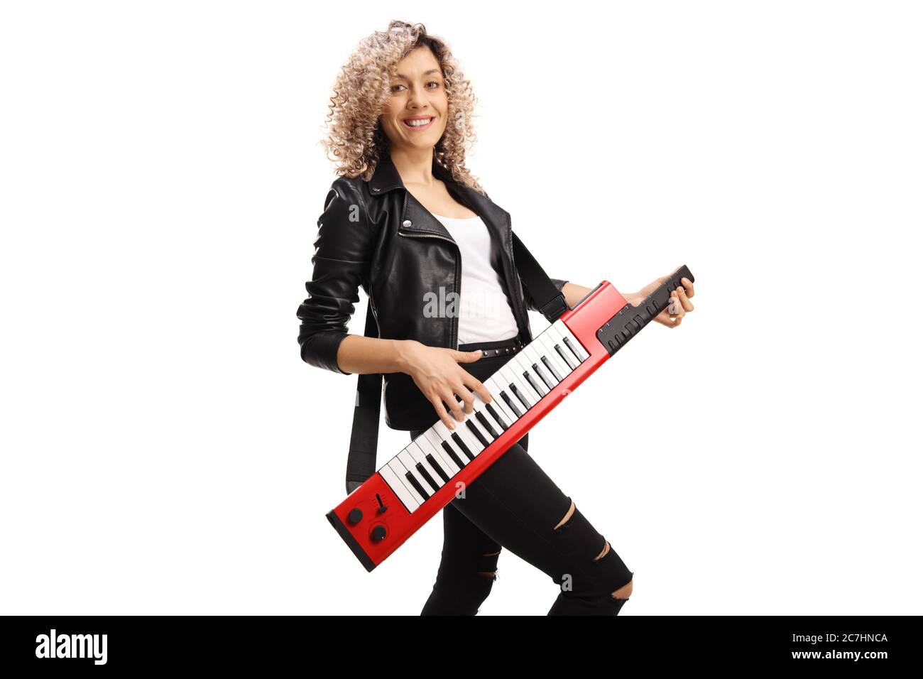 Female musician with a curly hair plaing on a red keytar isolated on ...