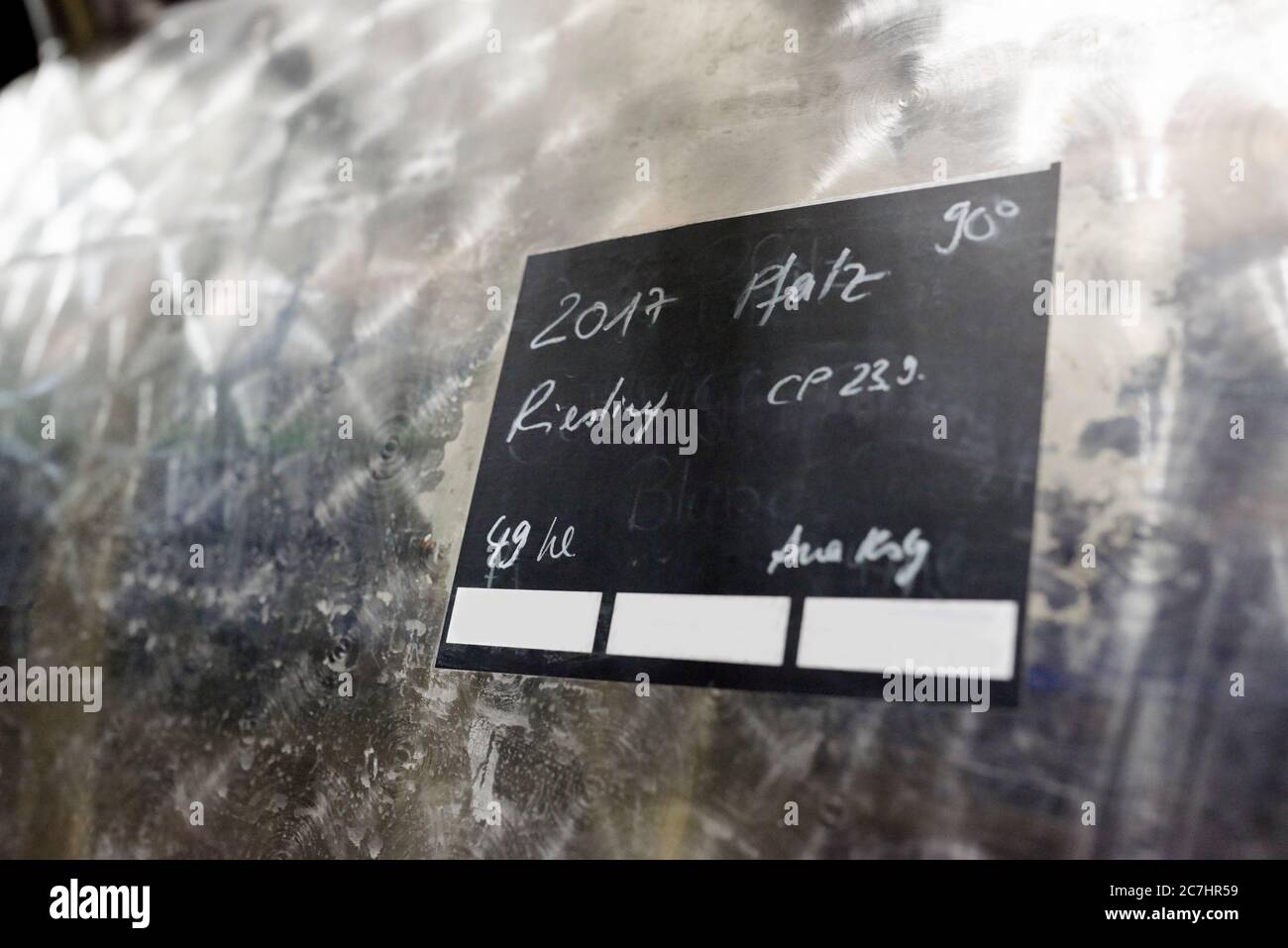 black tank label on stainless steel wine tank with chalk lettering ...