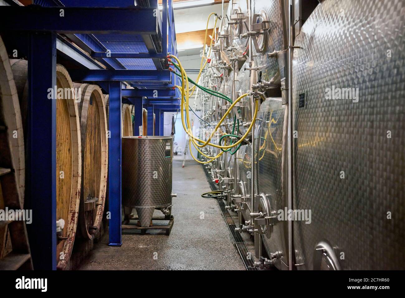 Stainless steel mash tanks and large wooden barrels in the fermentation ...
