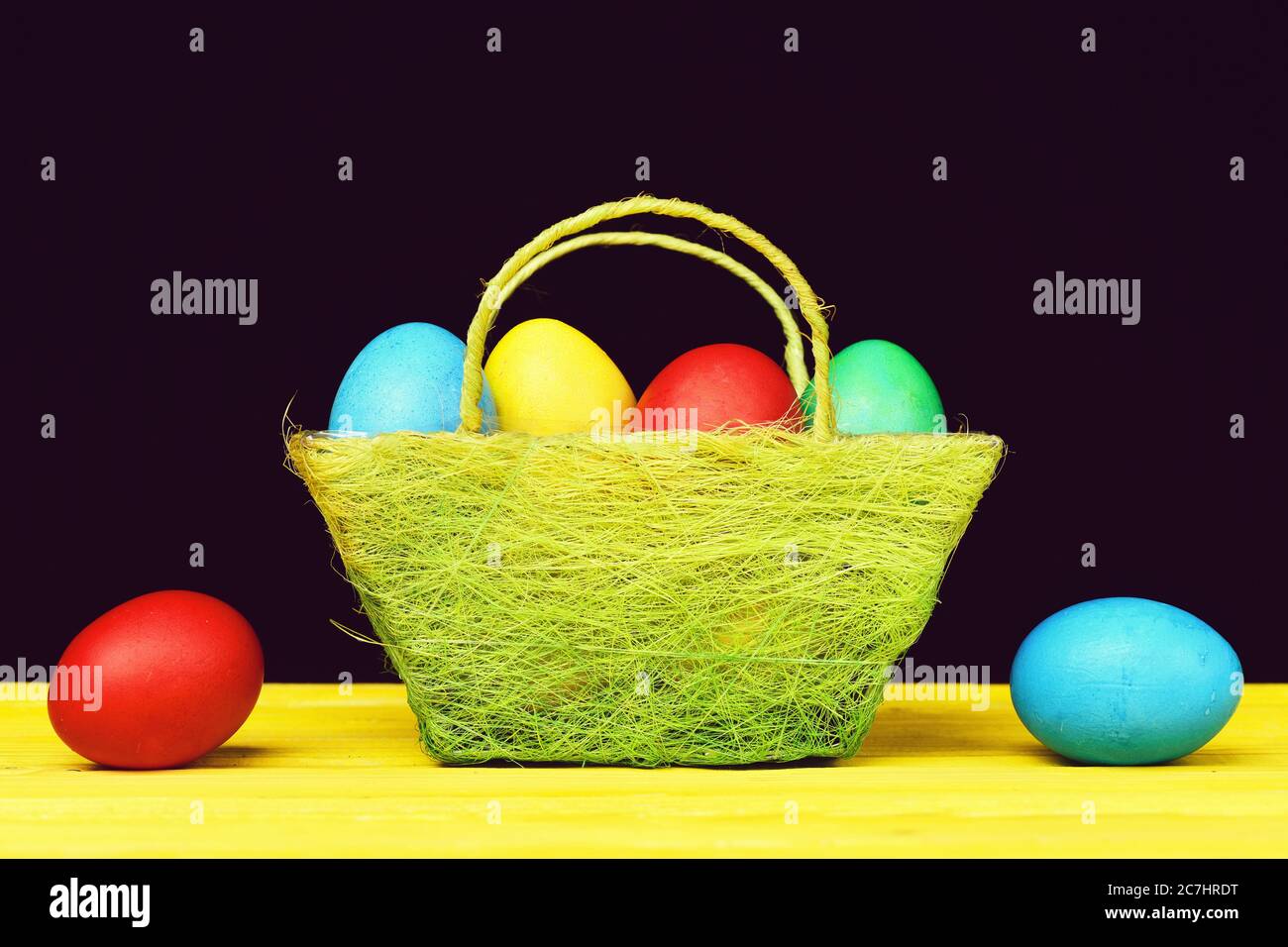 Easter eggs painted in red, blue, yellow and green colours in light ...