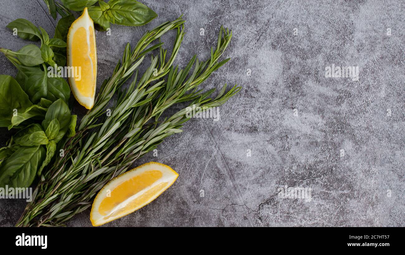 Selection of herbs and spices on stone background. Rosemary, basil and ...
