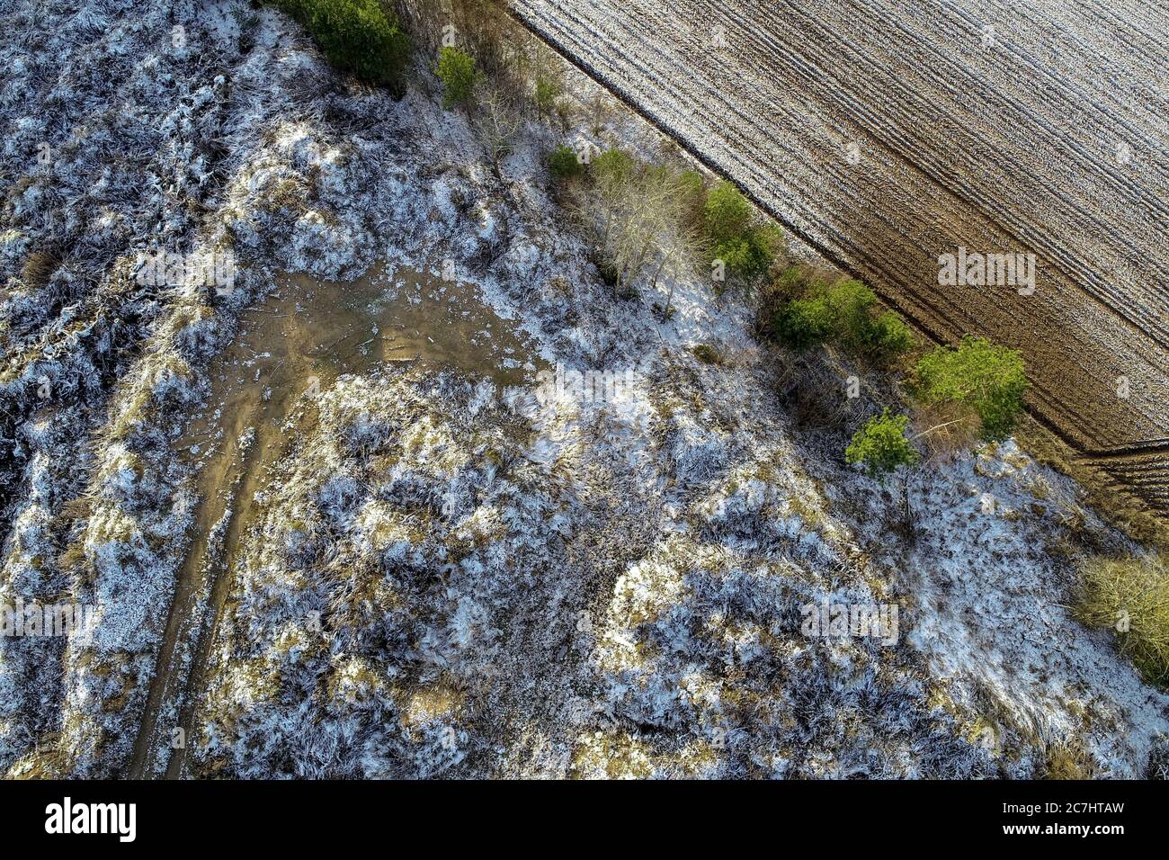 Overhead shot of an agricultural field with drops of snow in the ...