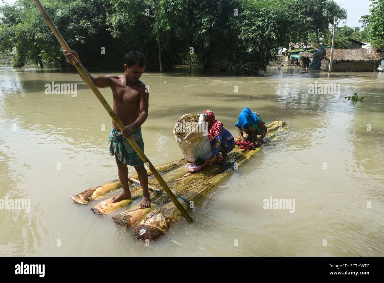 Morigaon, India. 17th July, 2020. Villagers uses a banana tree raft to ...