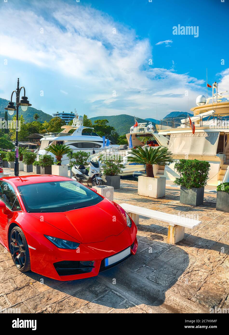 View of waterfront with boats and yachts moored up in town Budva city ...
