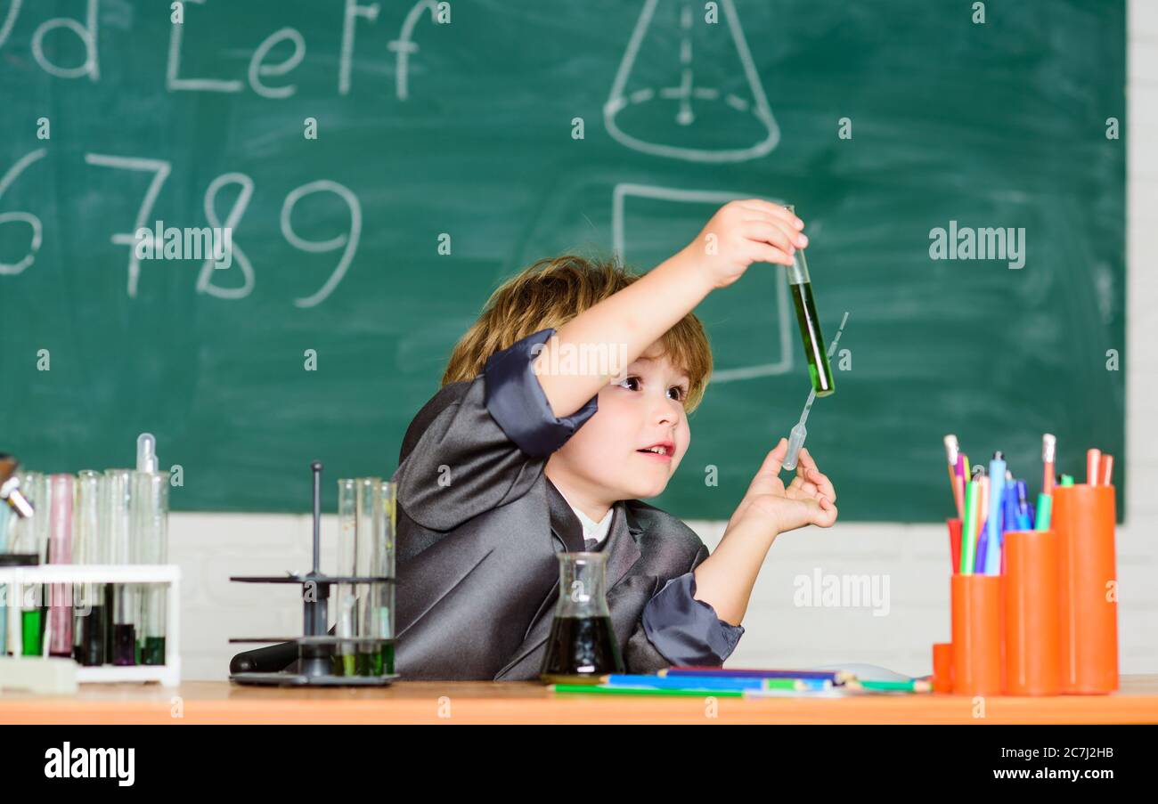 Little kid learning chemistry in laboratory. Little boy at the ...