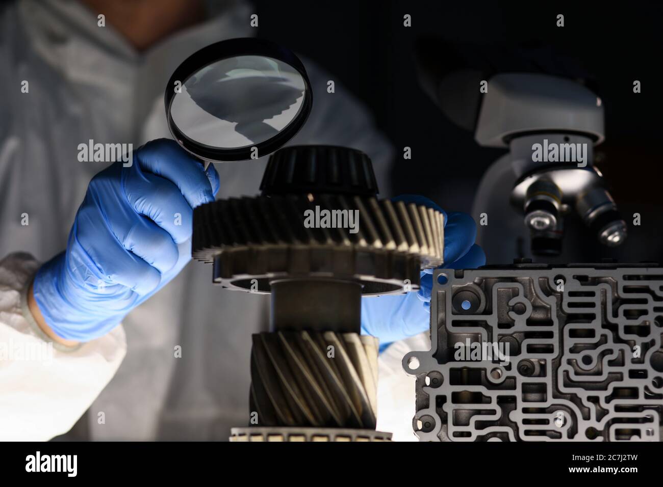 Man in lab examines parts of vehicle Stock Photo - Alamy