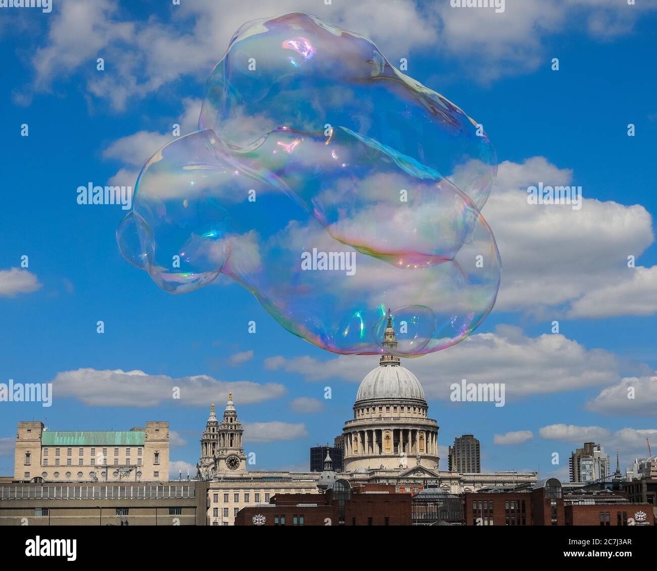 London, UK, 17th July 2020. A soap bubble artist's giant, contorting ...