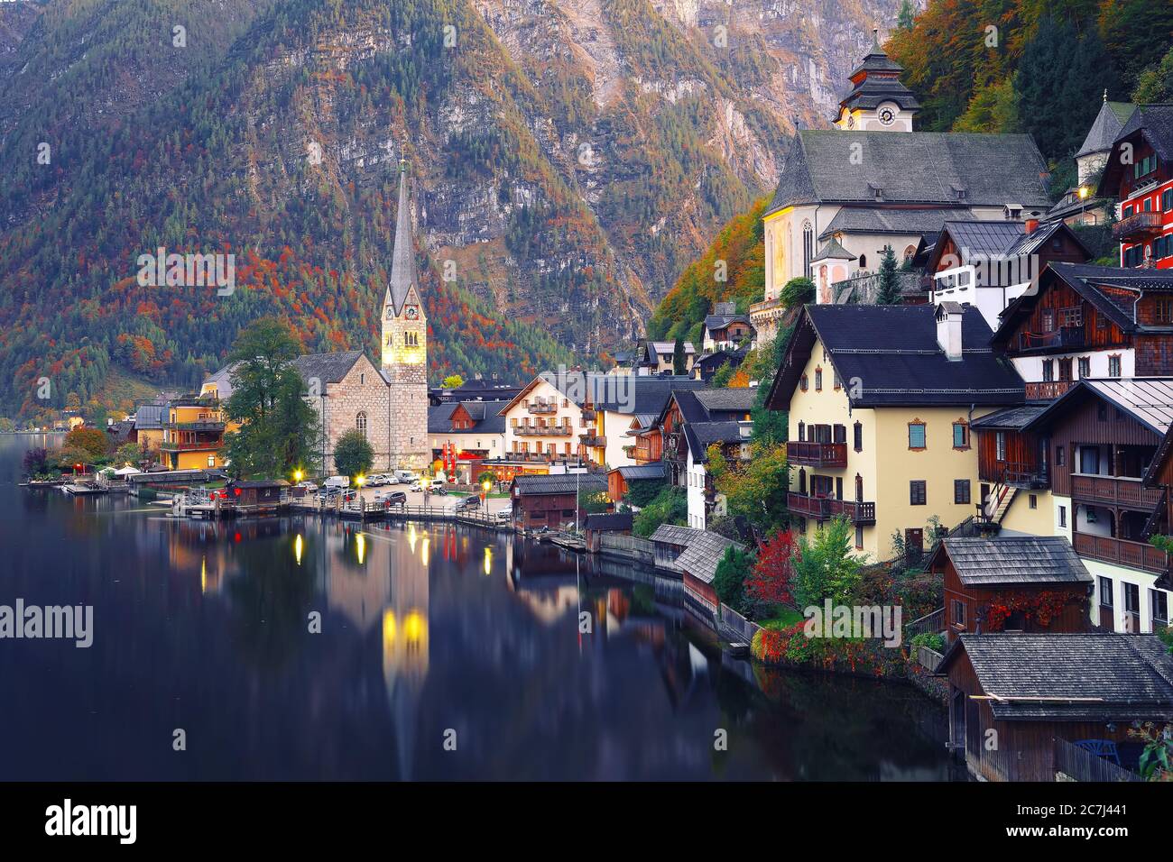 Autumnal sunset of famous Hallstatt lakeside town reflecting in ...