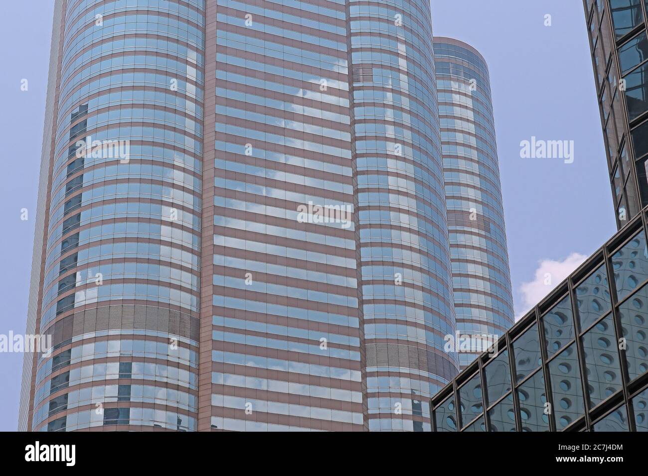 Modern tall buildings with glass facades and blue sky in background ...