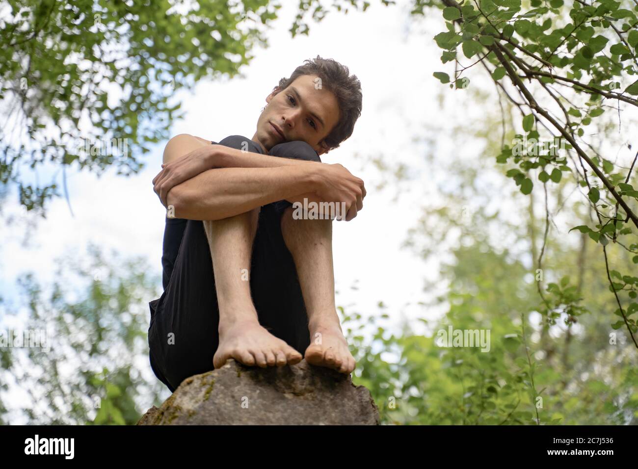 Hugging knees hi-res stock photography and images - Alamy