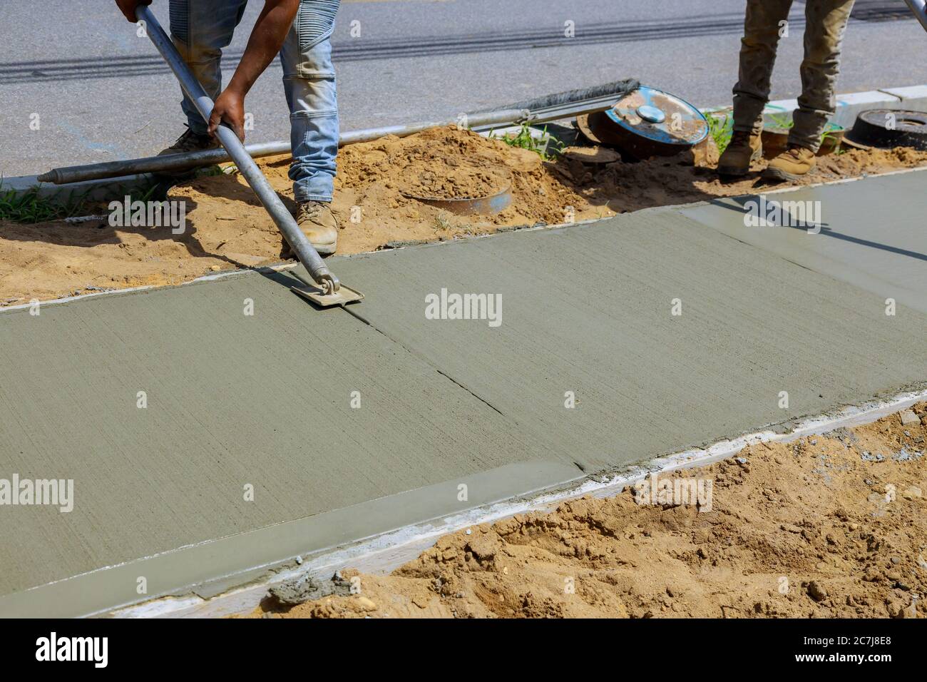 Process of installing construction of new sidewalks laying concrete ...