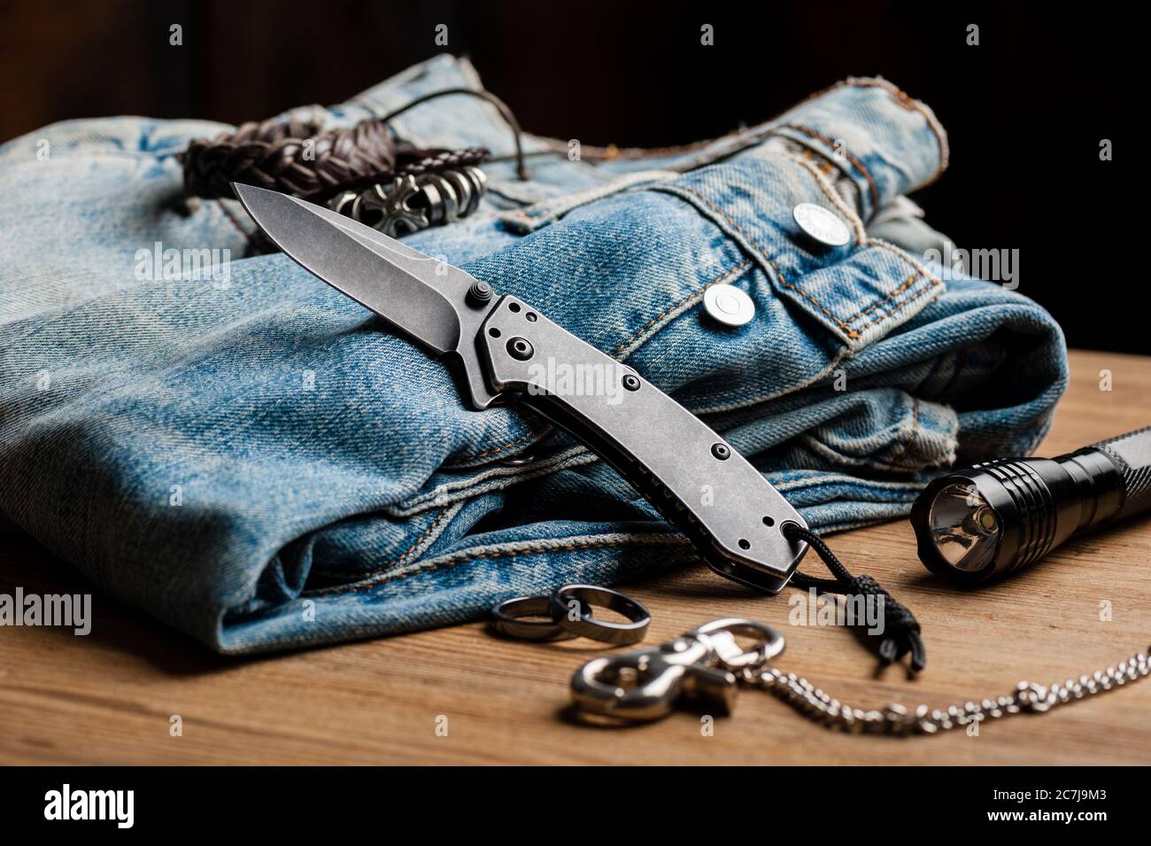 folding knife and jeans. closeup stainless steel pocketknife with ...