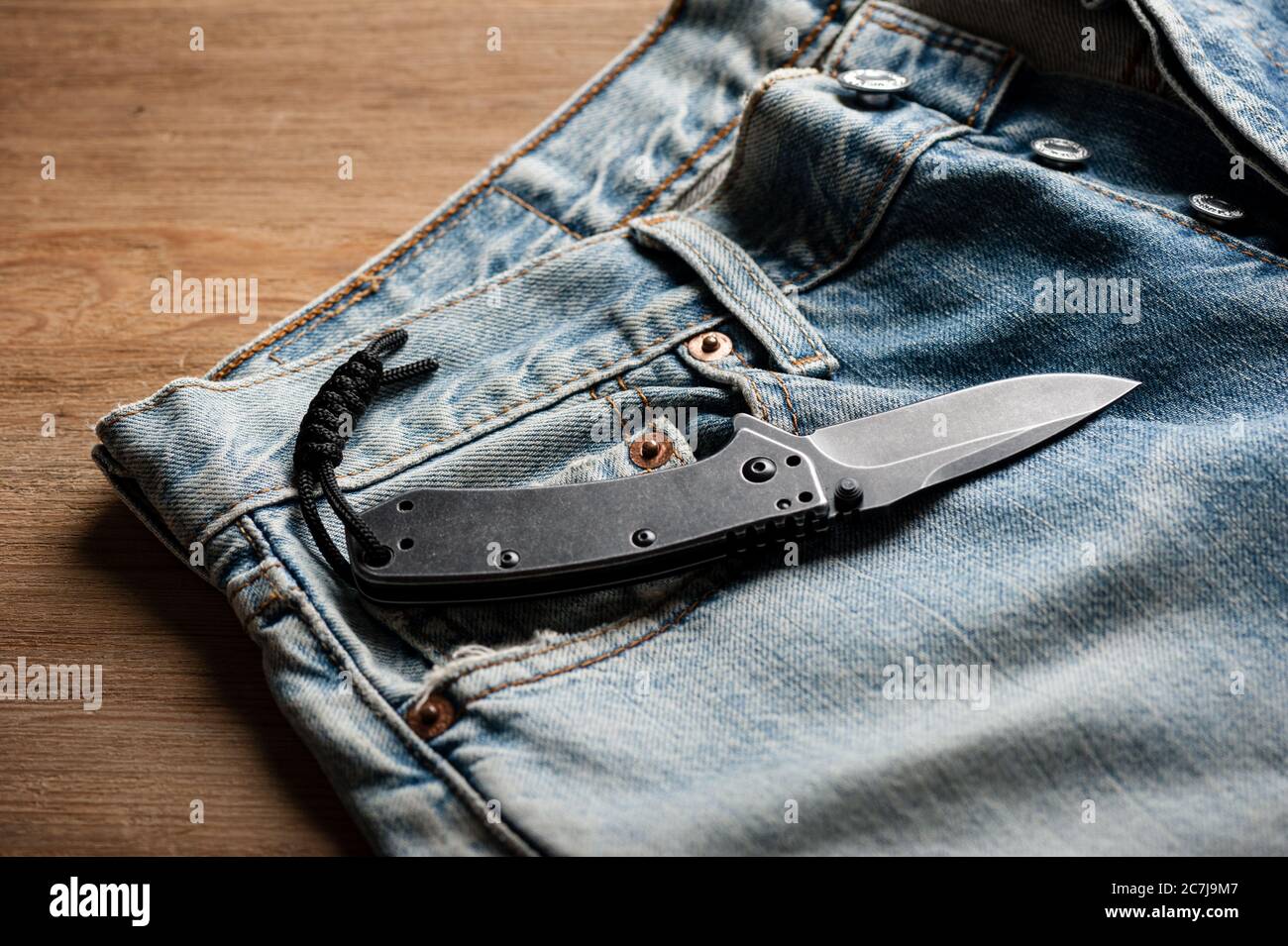 folding knife and jeans. closeup stainless steel pocketknife with ...