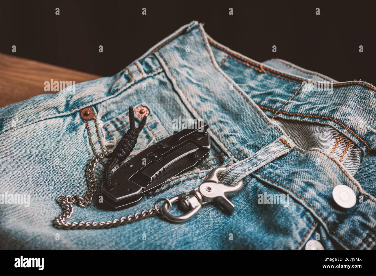 folding knife and jeans. closeup stainless steel pocketknife with ...