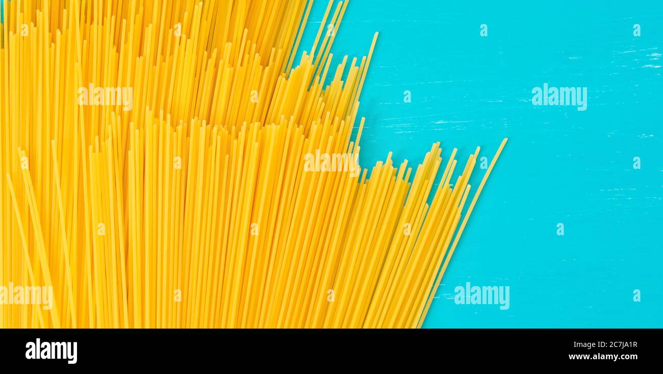 Raw spaghetti lying on the table in several layers in horizontal format ...