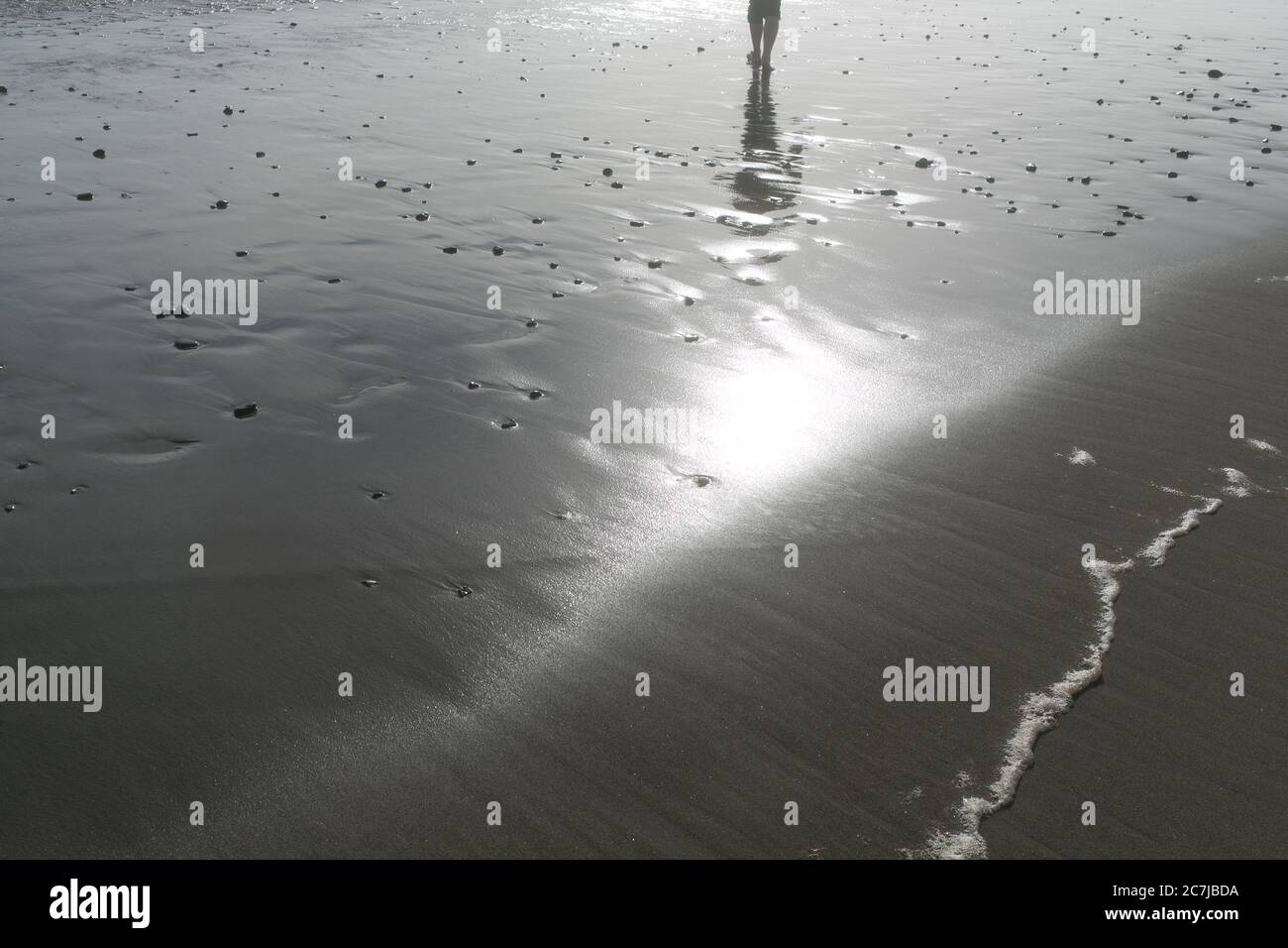 Breathtaking scenery of the sun shining through the ocean waves moving ...
