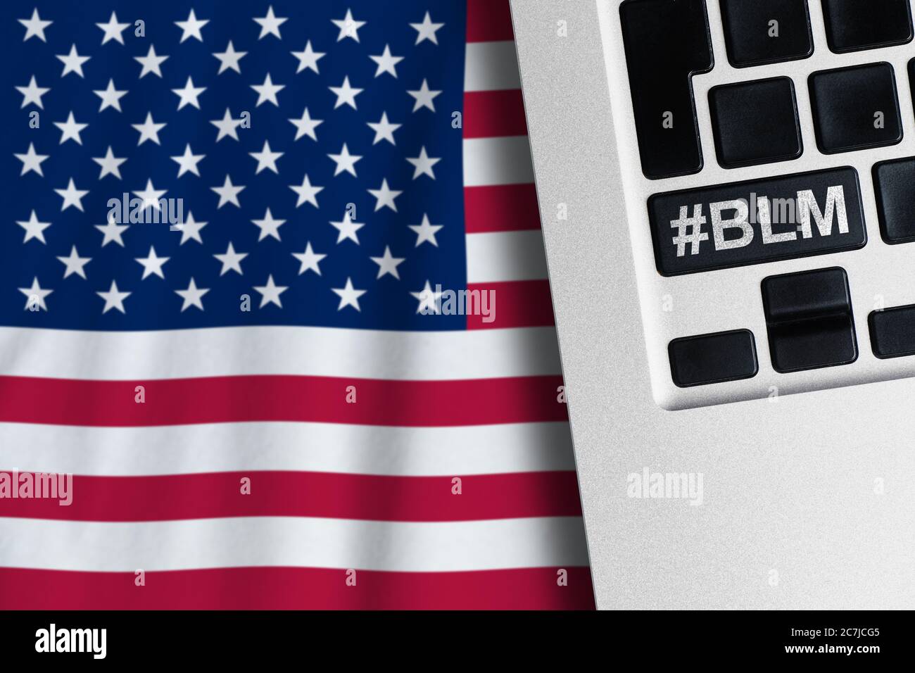 Hashtag BLM on a laptop keyboard with an American flag background Stock ...
