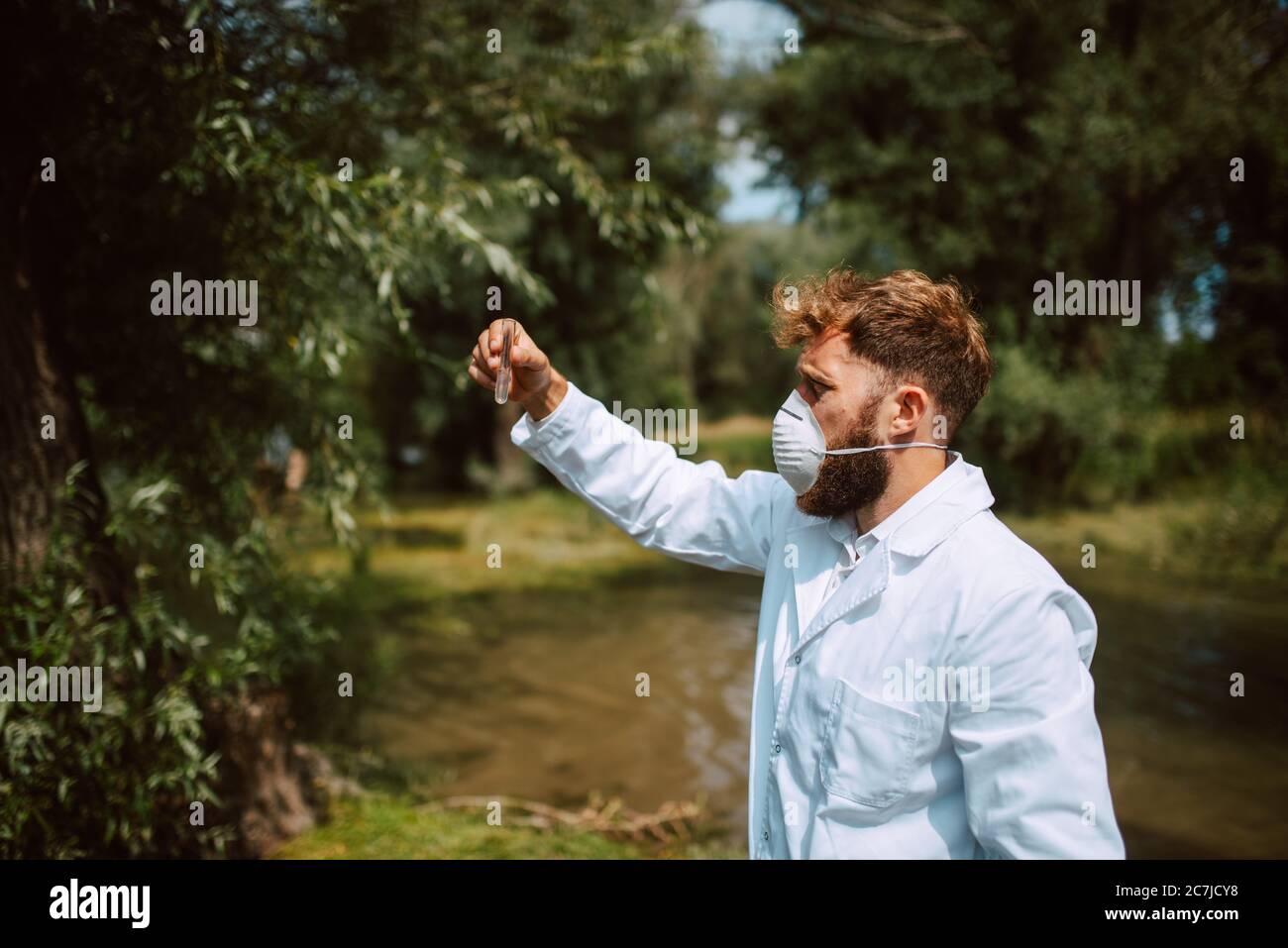 Male caucasian scientist biologist and researcher in protective suit ...