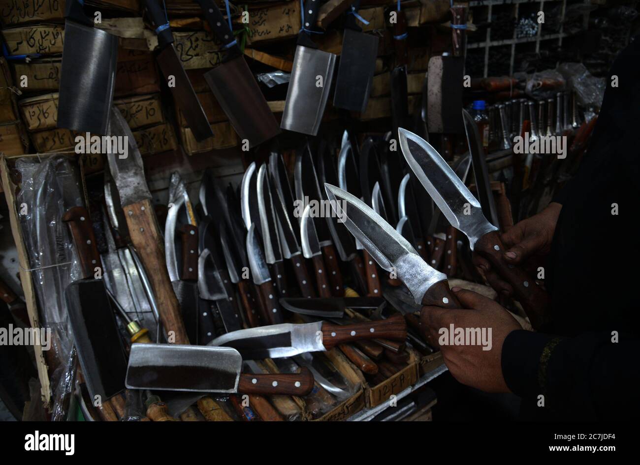 Lahore, Pakistan. 17th July, 2020. Pakistani blacksmiths sharpens meat ...