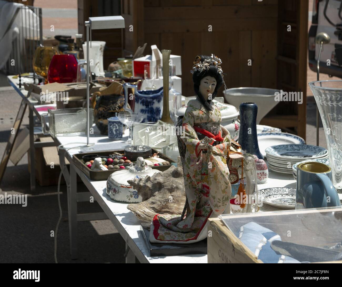 Table full of marvelous ceramic silverware and a statue of an Asian ...