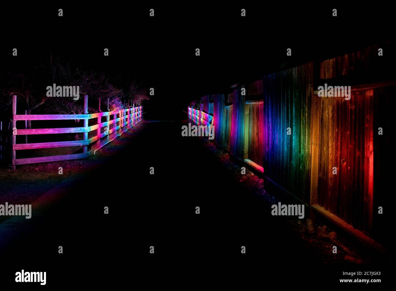Beautiful RGB light painting along a fence at night time Stock Photo ...