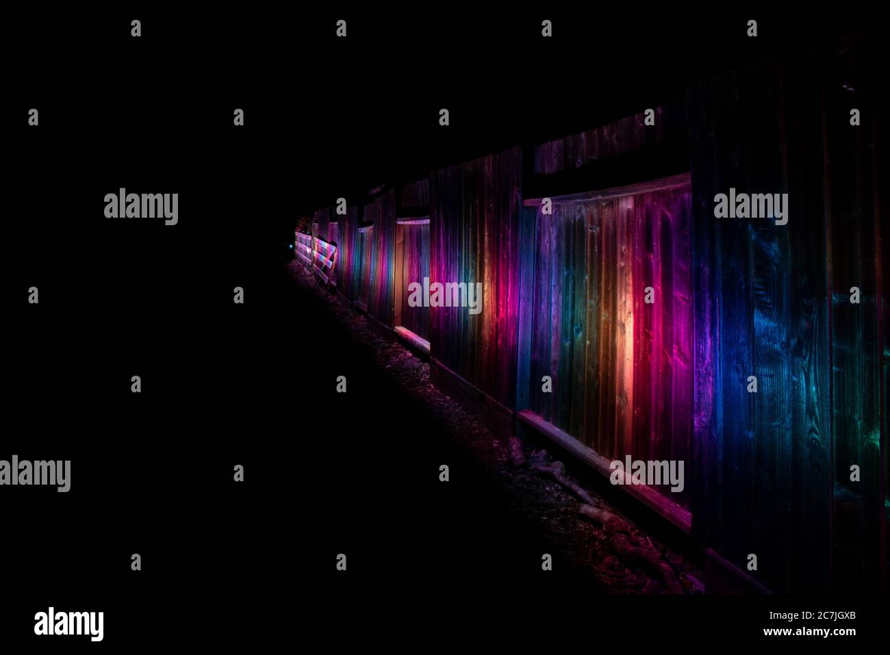 Beautiful RGB light painting along a fence at night time Stock Photo ...