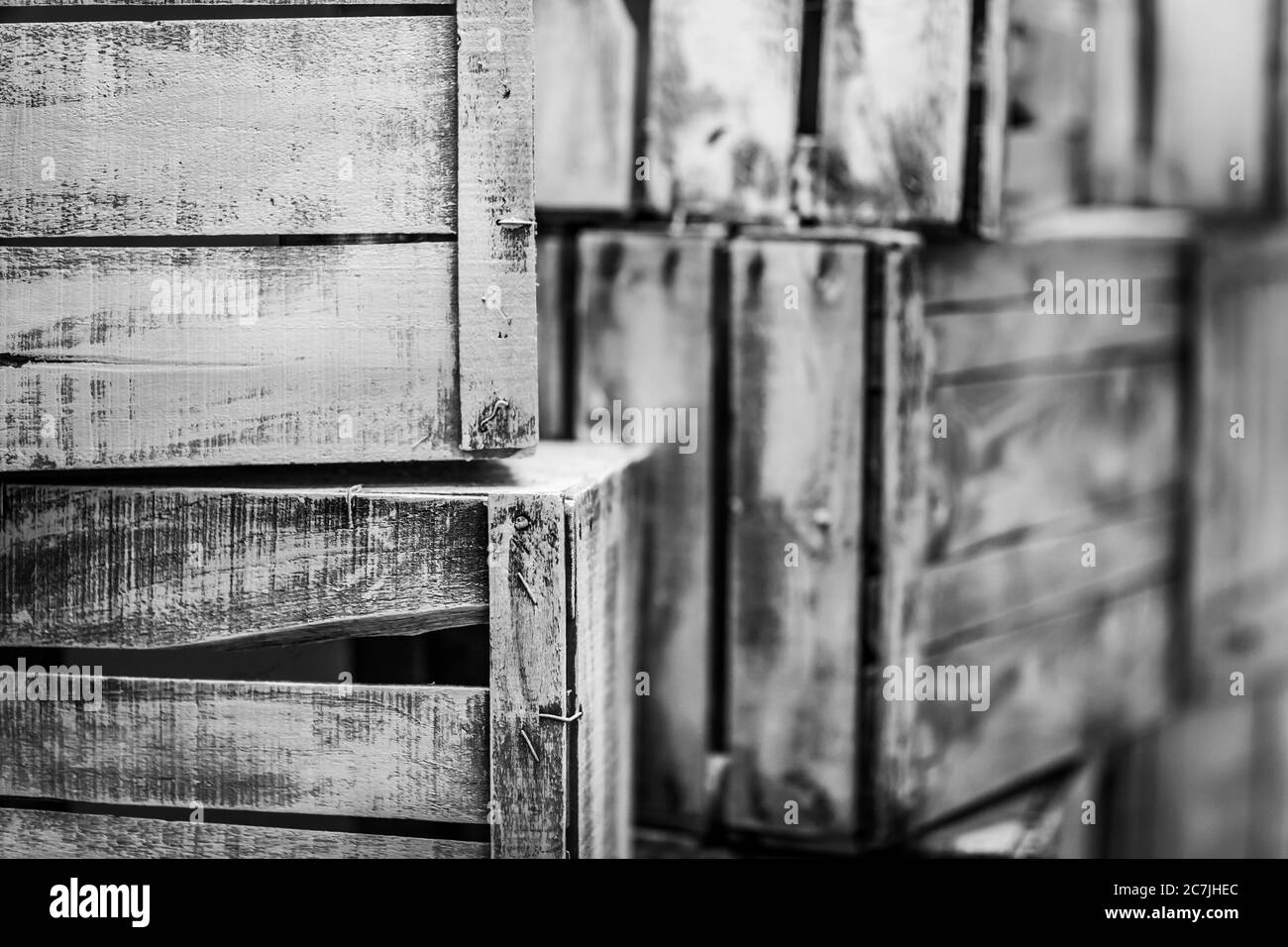 Closeup greyscale shot of wooden boxes perfect for using as a ...