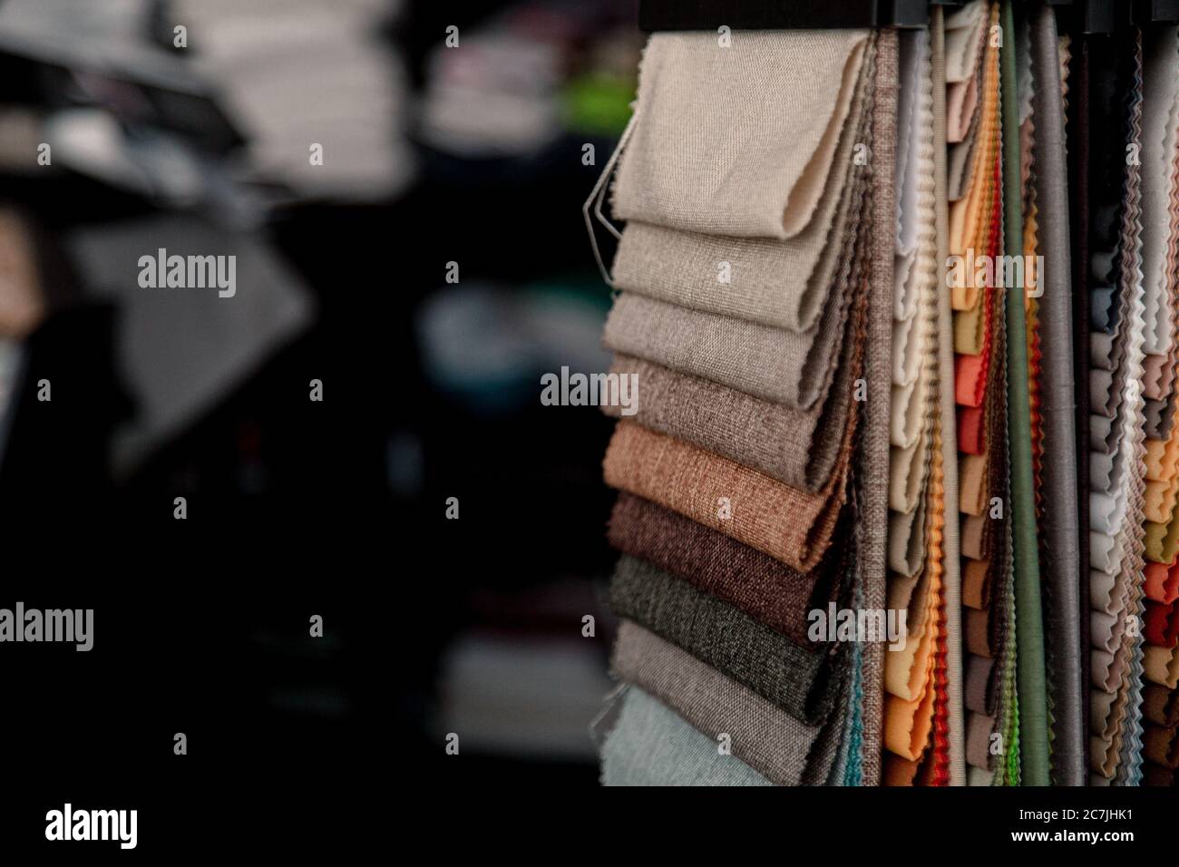 Lot of colorful folded textiles in a tailors studio Stock Photo - Alamy