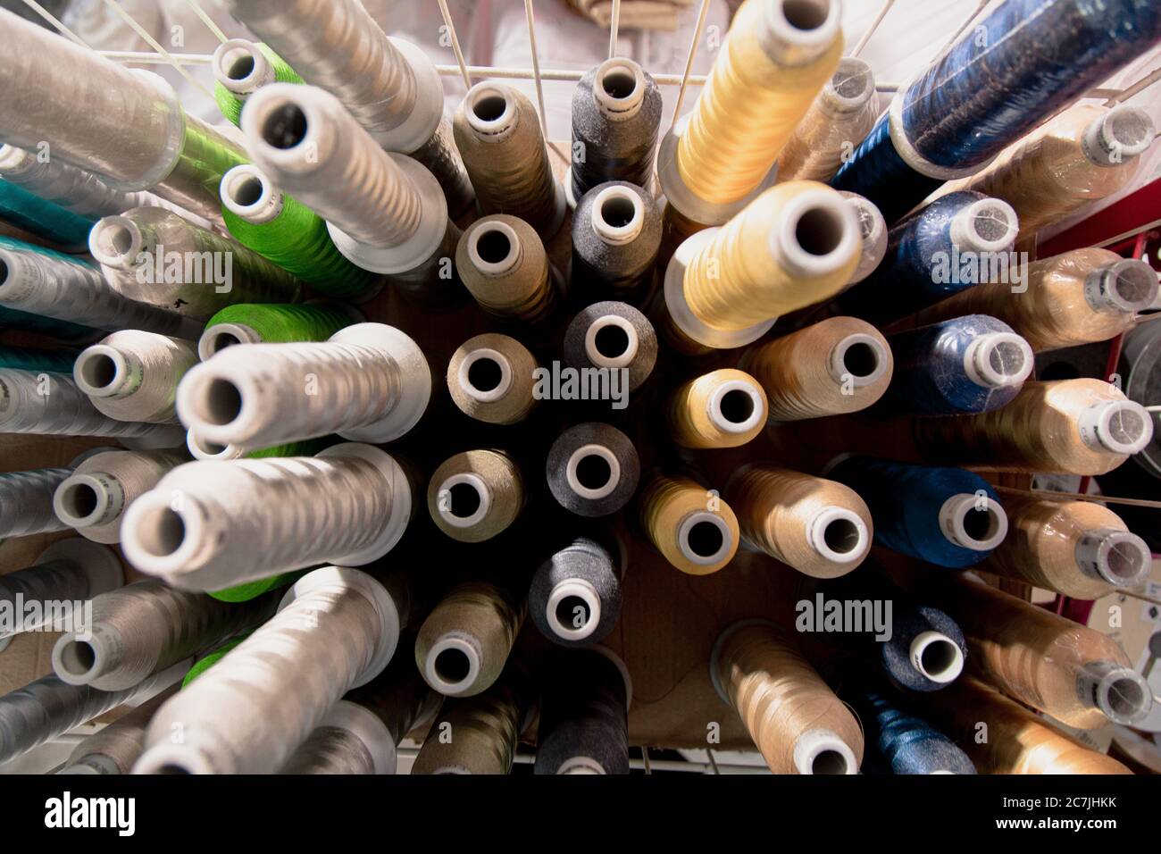 Lot of colorful sewing threads in a textile factory Stock Photo - Alamy