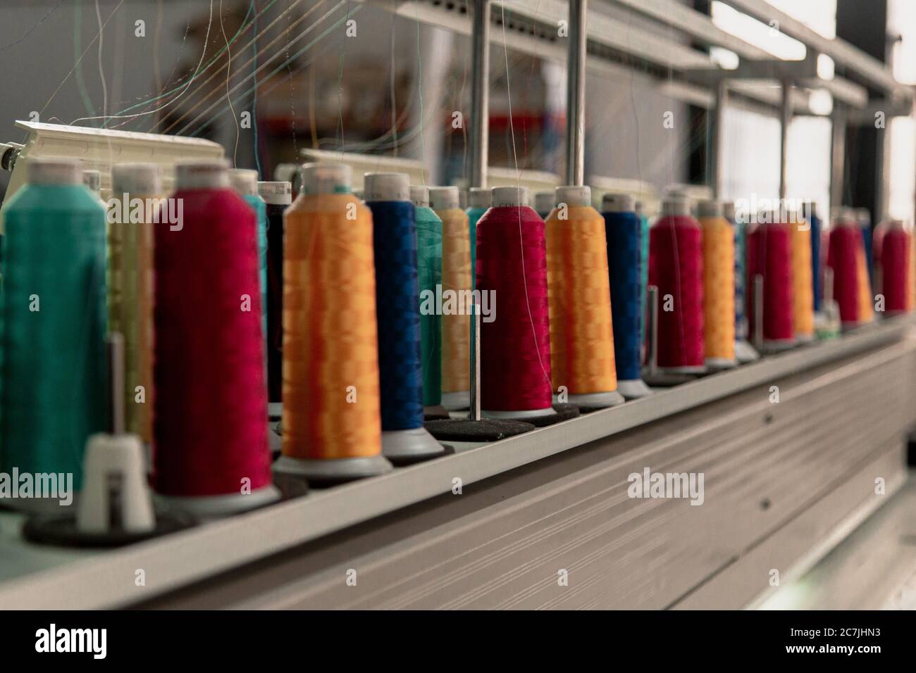 Lot of colorful sewing threads on the shelf in a tailors studio Stock ...